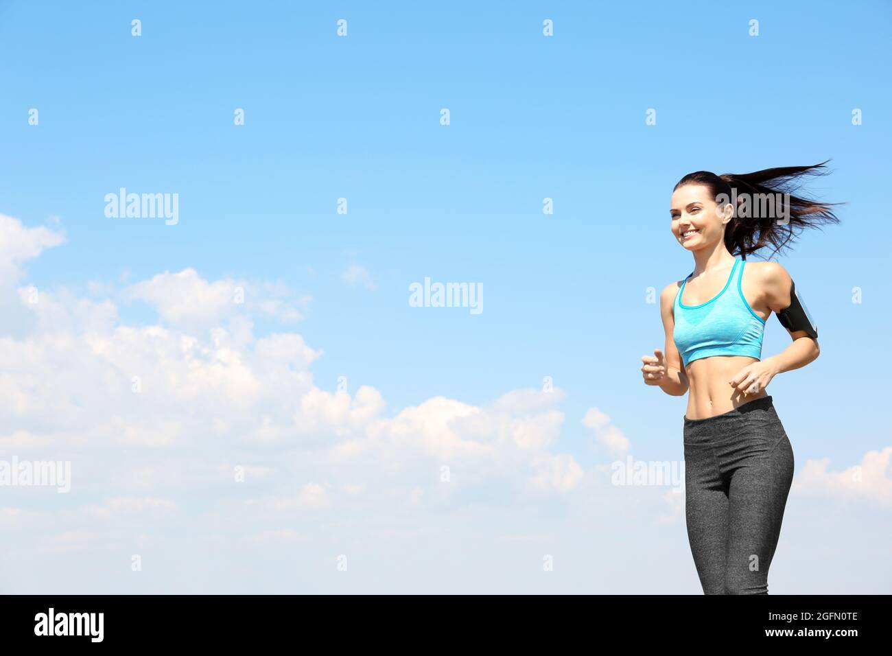 Attractive fitness woman running outdoors Stock Photo - Alamy