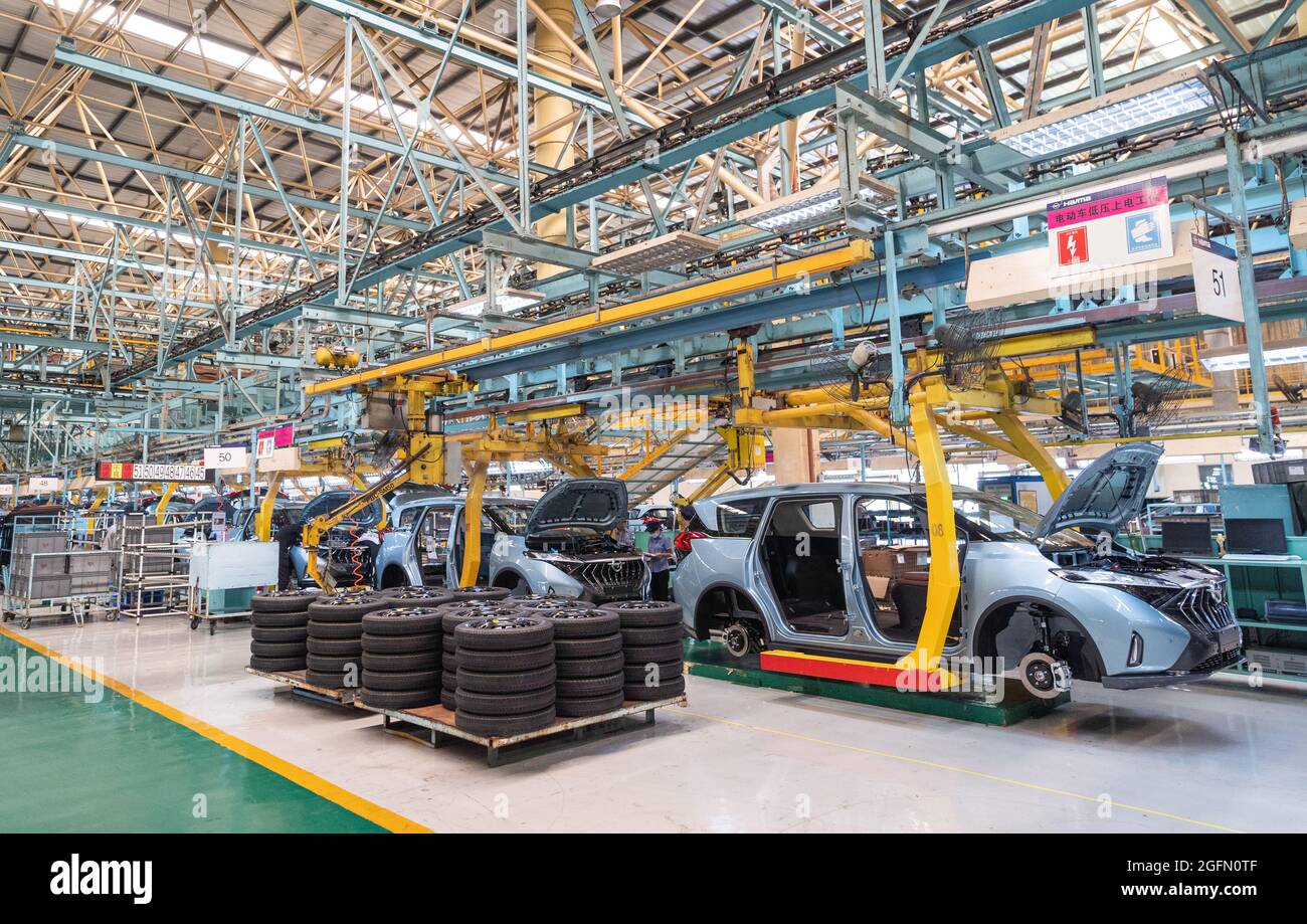 Workers assemble cars produced at a factory of Haima Automobile in ...