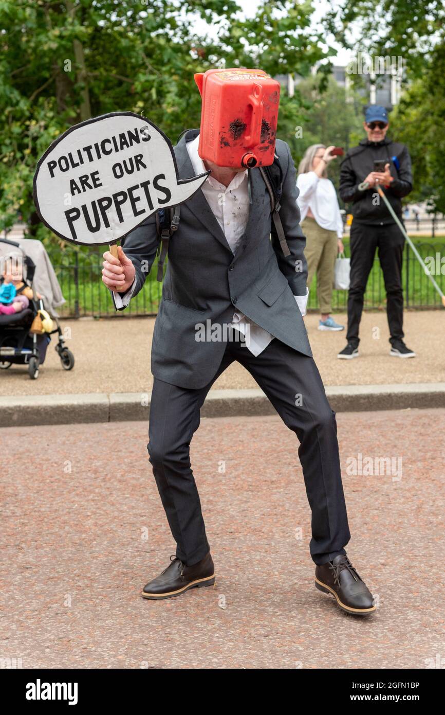 London, UK. 26th Aug, 2021. A protester is seen with an oil can on his ...