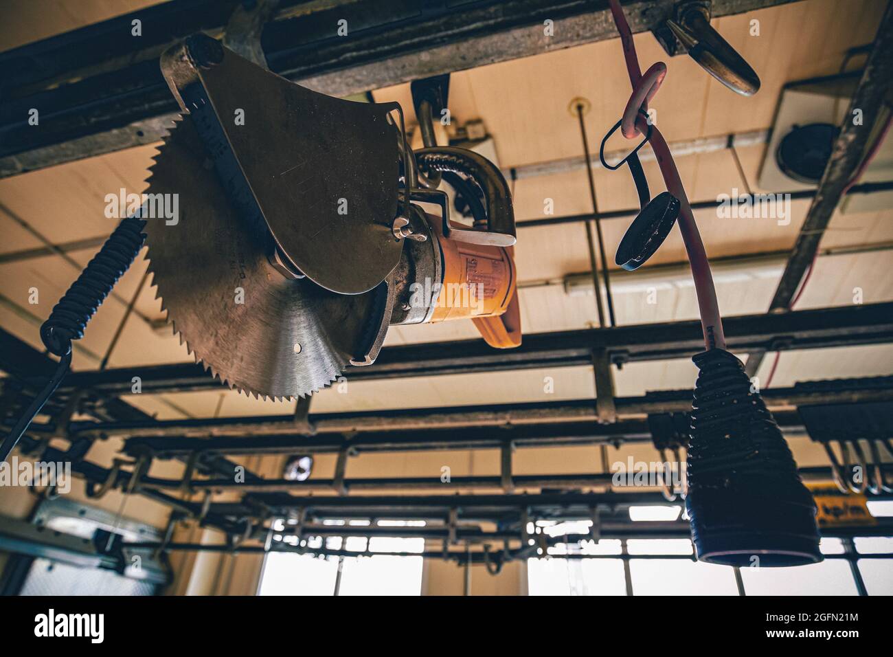 Low angle shot of hanged slaughtering sharp equipment at slaughter ...