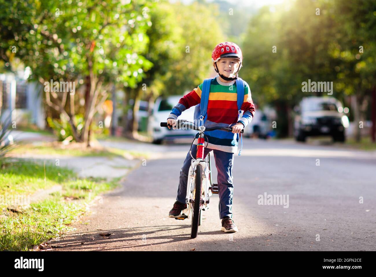 Child going to school on bike. Kids ride bicycle. Safe way to ...