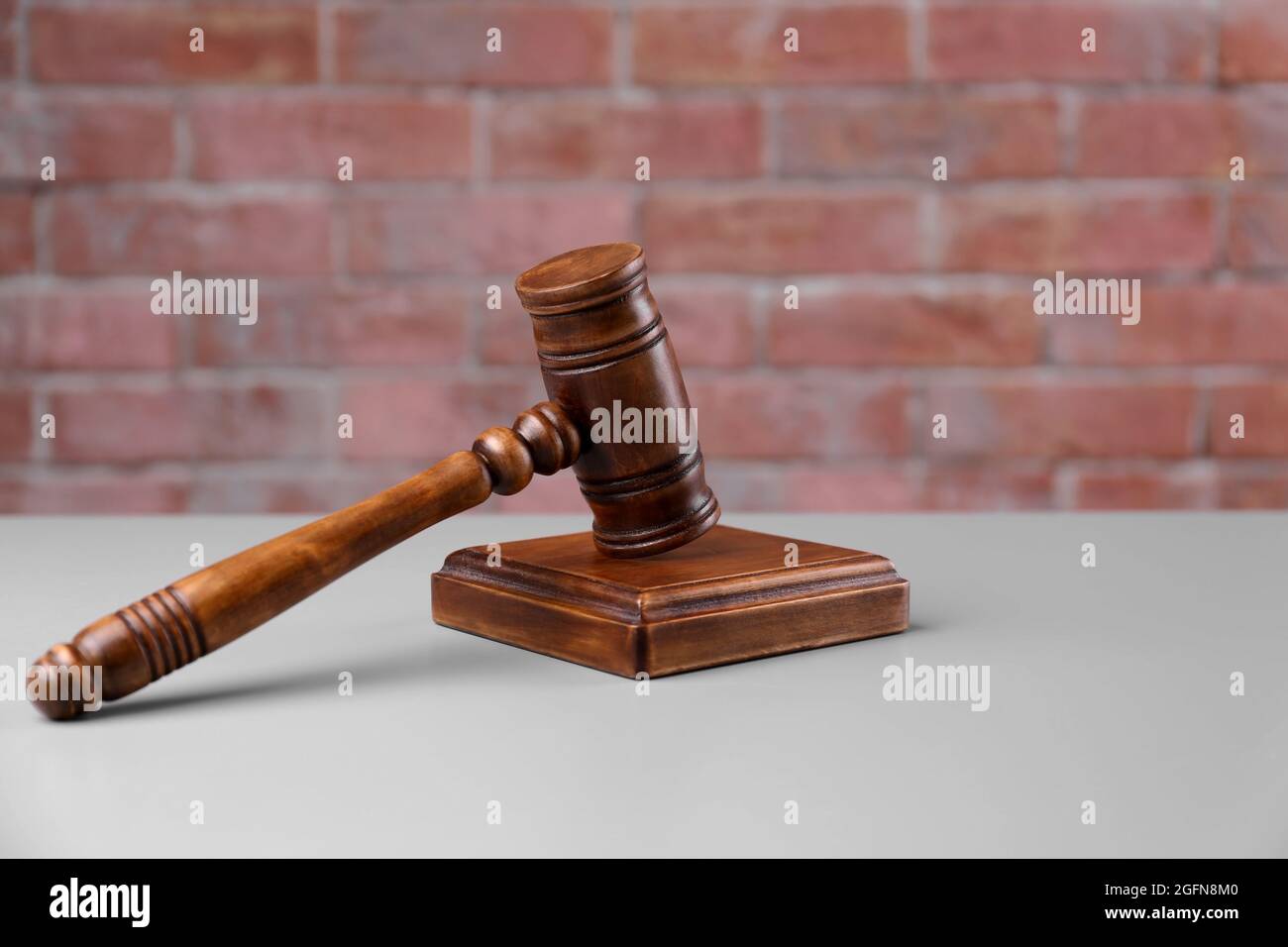 Gavel and sound block on brick wall background Stock Photo - Alamy