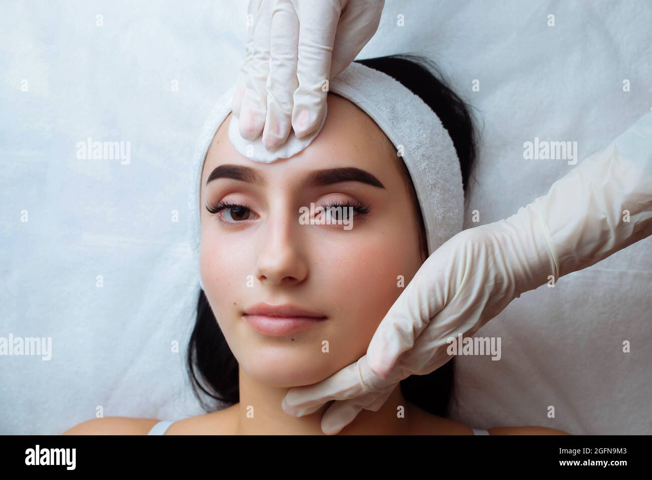 Caring for the skin. Cosmetic cream on a woman's face. Spa beauty ...