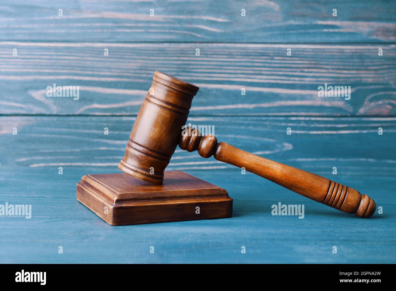 Judge's gavel and sound block on wooden wall background Stock Photo - Alamy