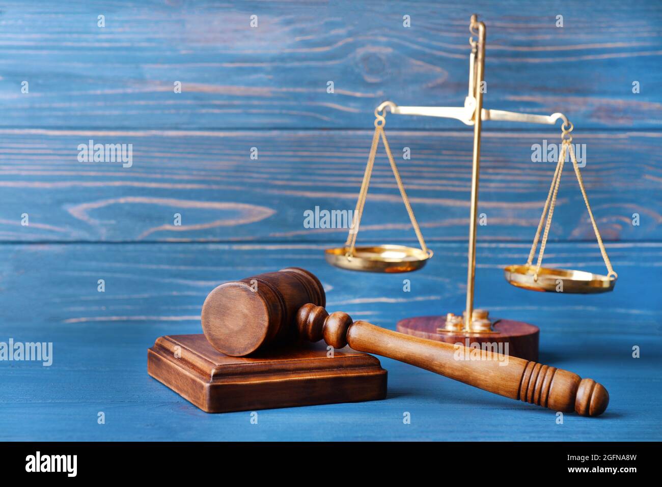 Judge's gavel and scales on wooden background Stock Photo - Alamy