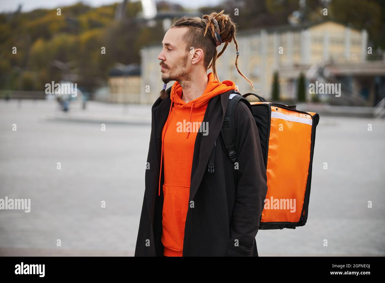 Stylish man working in a food delivery company Stock Photo - Alamy