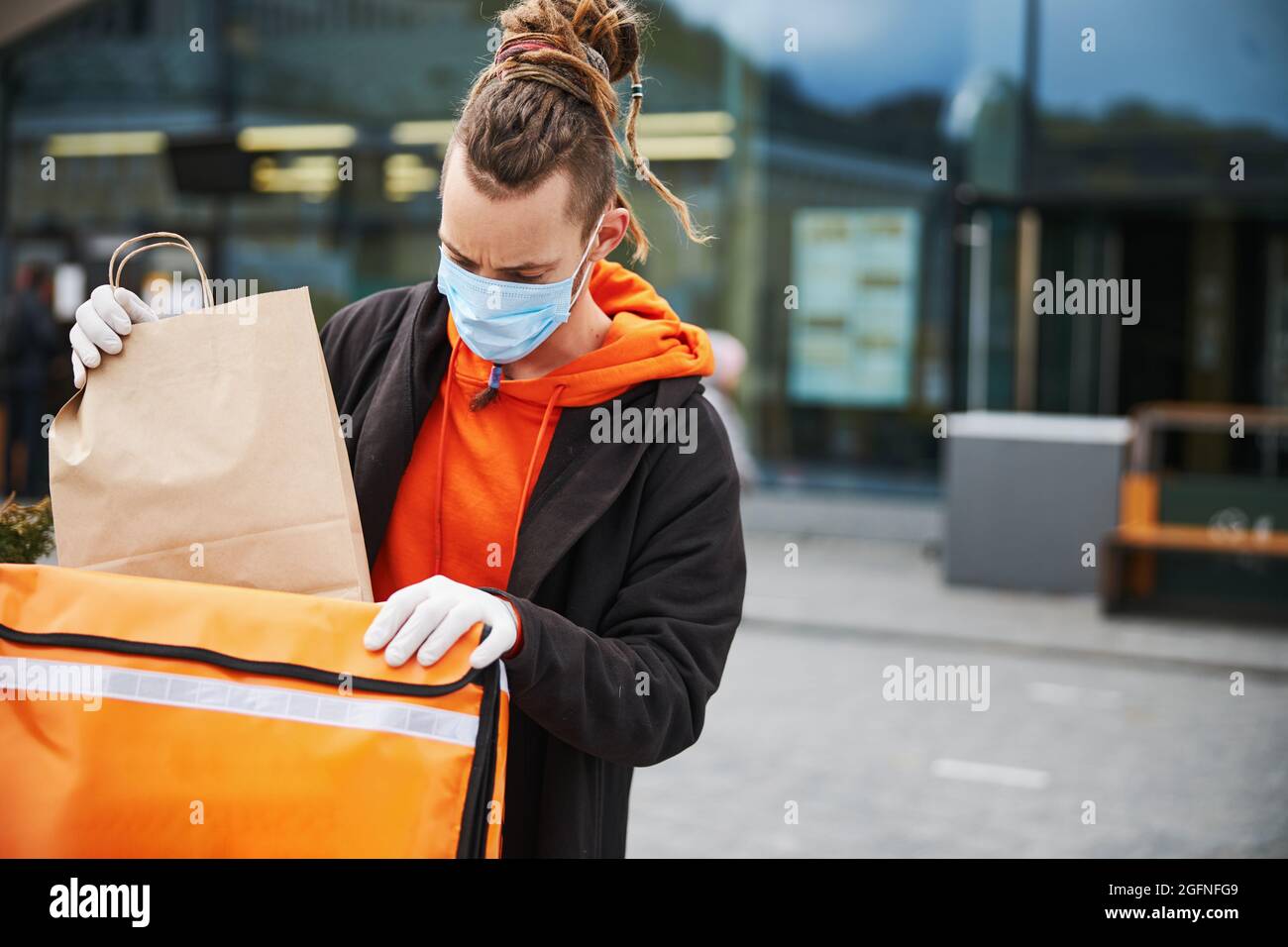 Cheerful delivery man backpack hi-res stock photography and images - Alamy