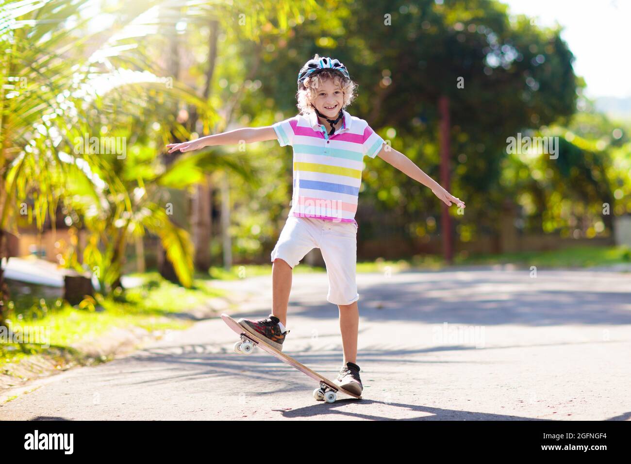 Kid with skateboard. Child riding skate board. Healthy sport and ...