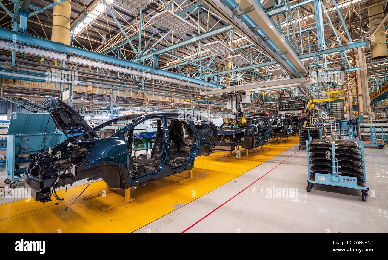 Workers assemble cars produced at a factory of Haima Automobile in ...