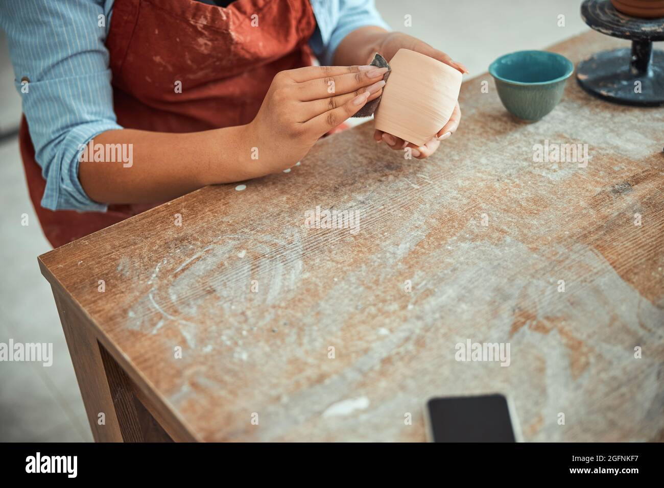 Female ceramist hands sanding clay pot in pottery workshop Stock Photo ...