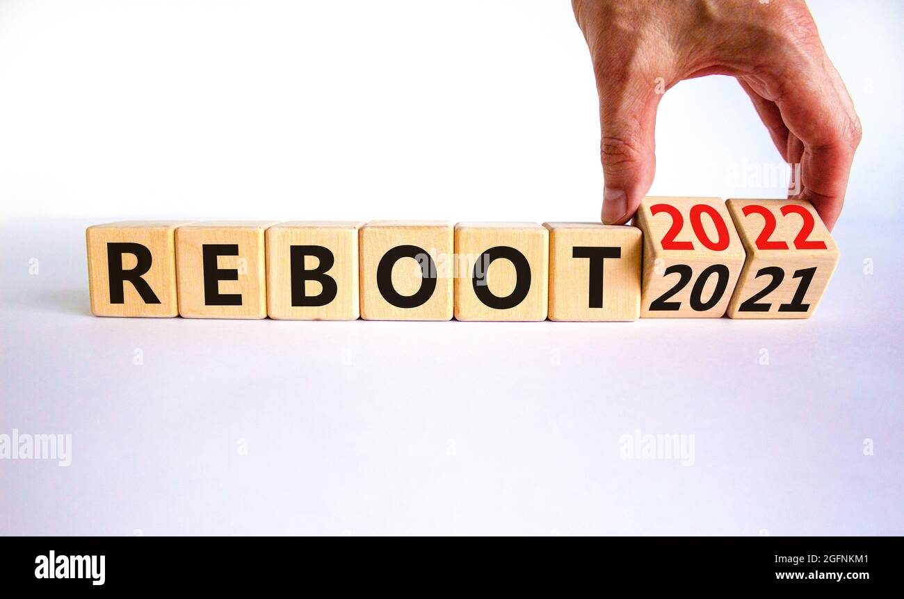2022 reboot new year symbol. Businessman turns wooden cubes and changes ...