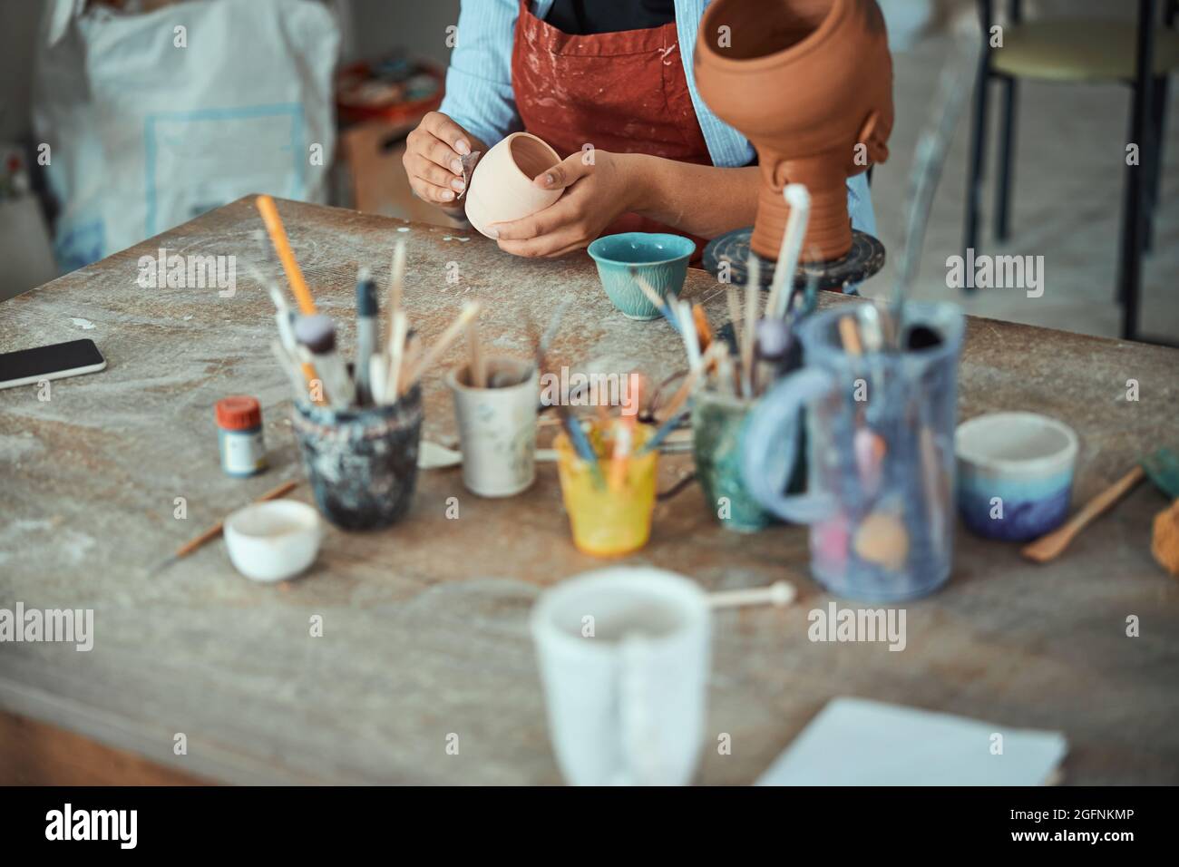 Female potter hands sanding ceramic pot in pottery workshop Stock Photo ...
