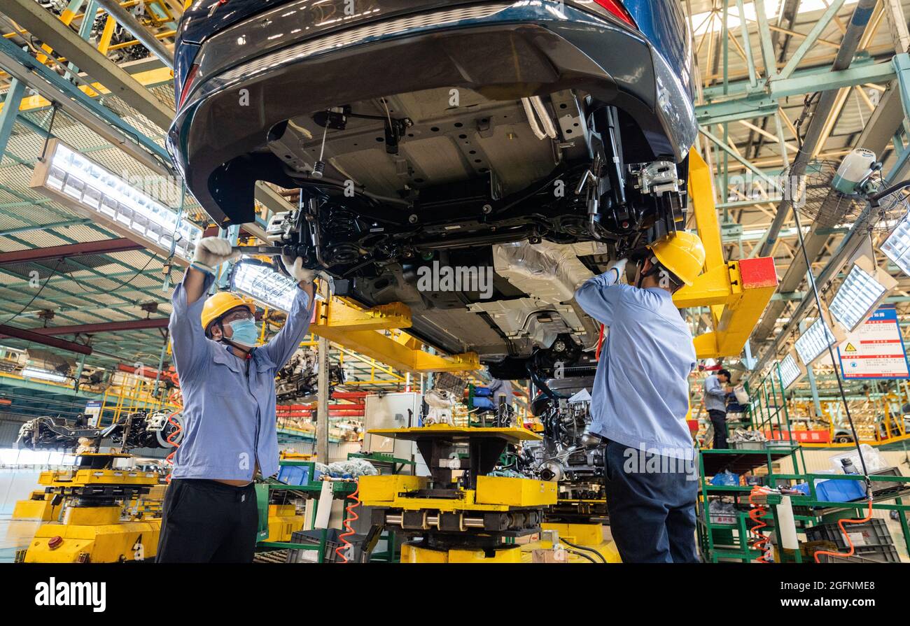 Workers assemble cars produced at a factory of Haima Automobile in ...
