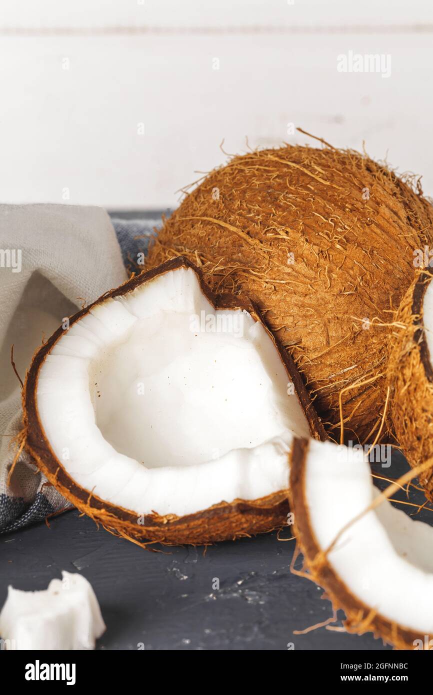 Pile of broken coconuts on ripped grey background Stock Photo - Alamy