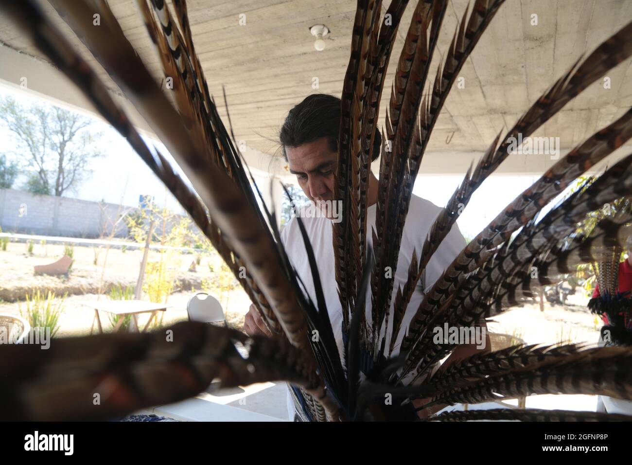 Non Exclusive: TEOTIHUACAN, MEXICO - AUGUST 26: A man puts the feathers ...