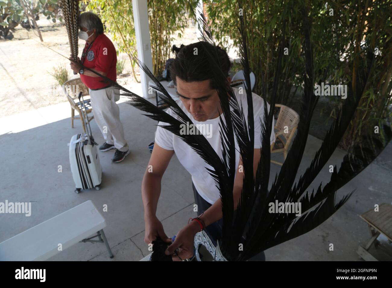 Non Exclusive: TEOTIHUACAN, MEXICO - AUGUST 26: A man puts the feathers ...