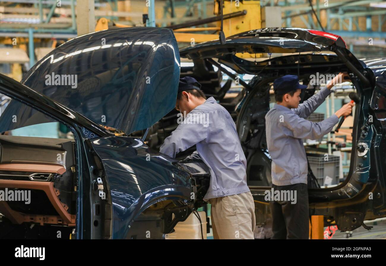 Workers assemble cars produced at a factory of Haima Automobile in ...