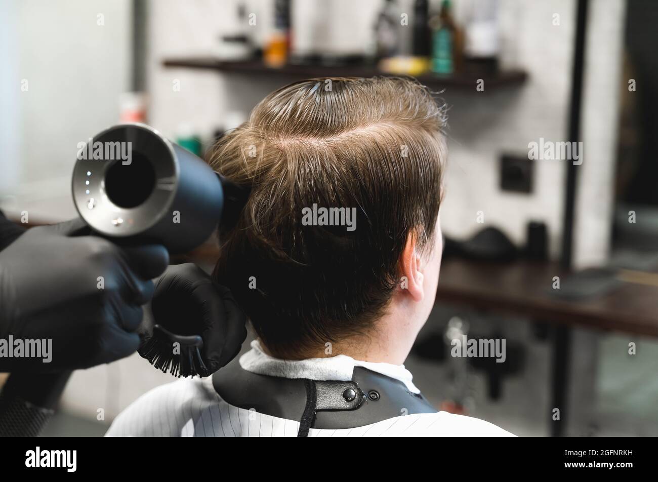 Barber drying client hair dryer hi-res stock photography and images - Alamy