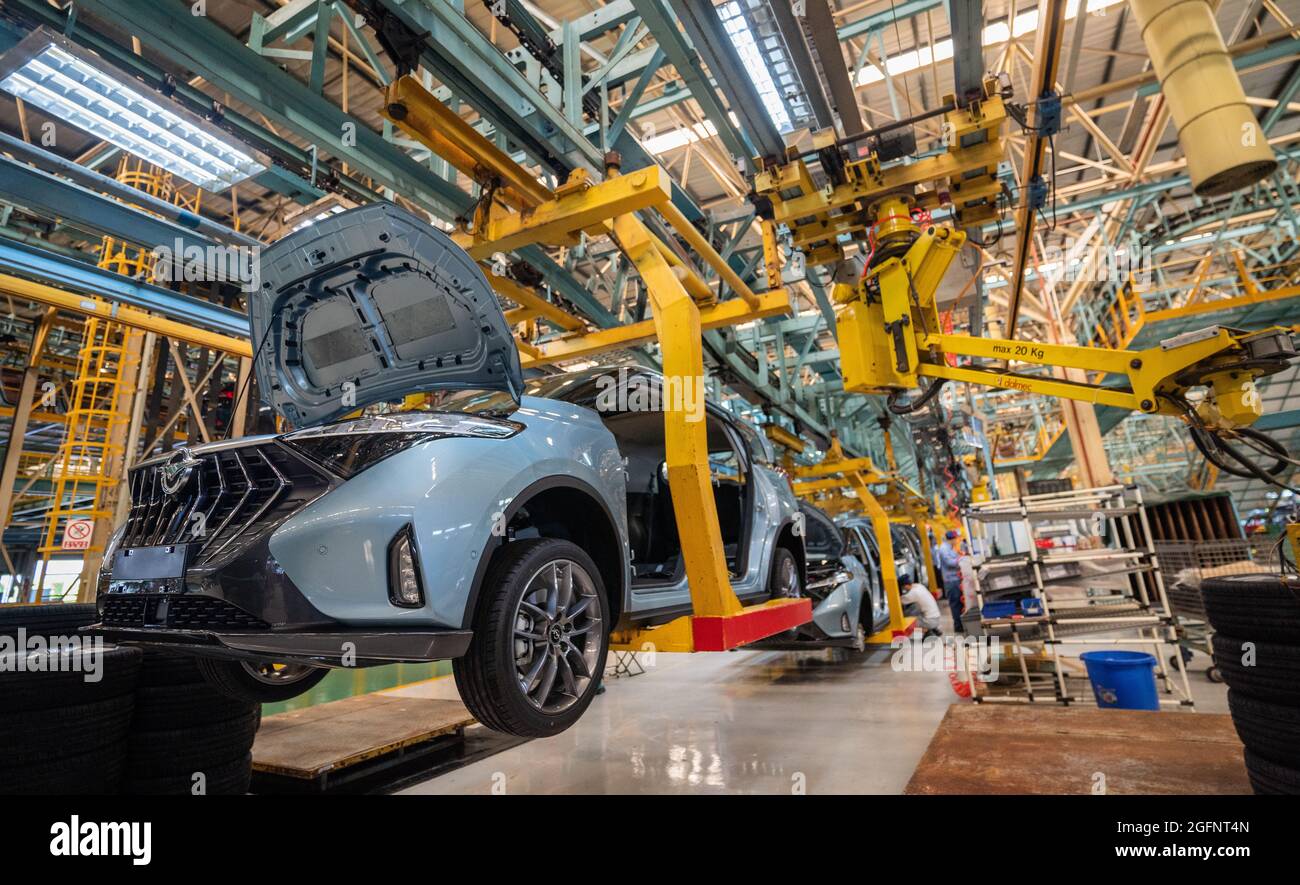 Workers assemble cars produced at a factory of Haima Automobile in ...