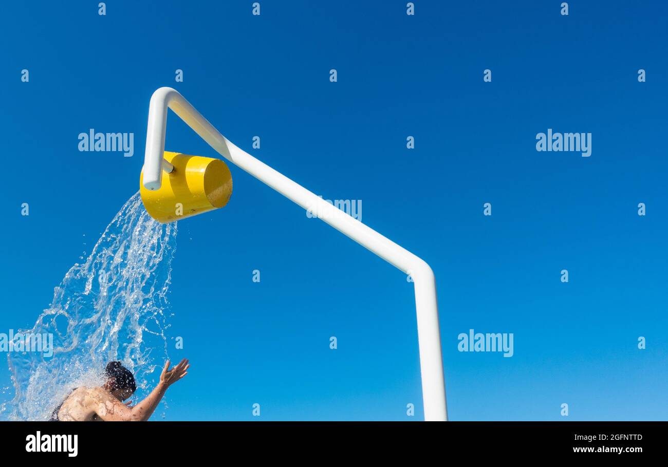 Woman taking outdoor shower Stock Photo - Alamy