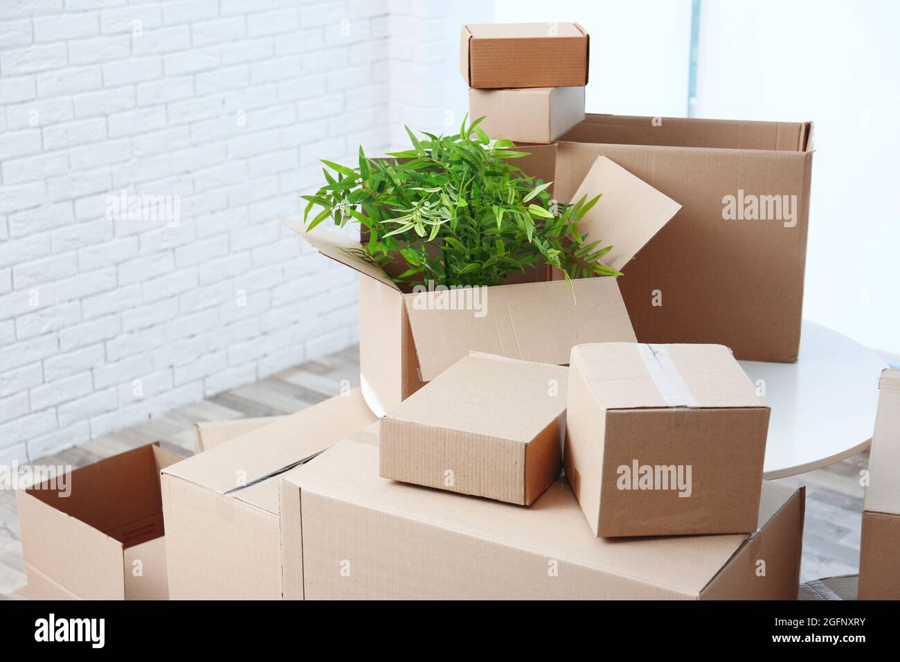 House moving concept. Boxes in empty room Stock Photo - Alamy