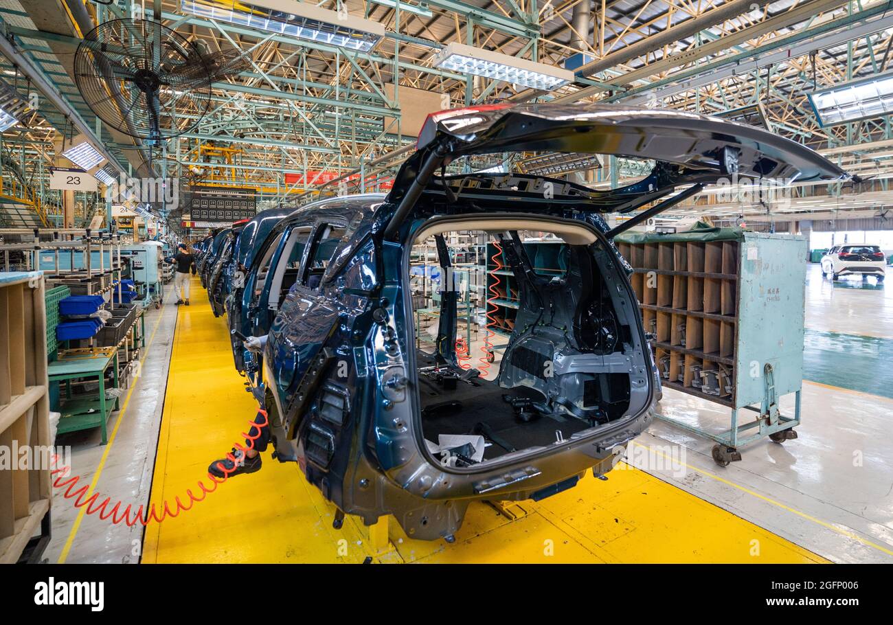 Workers assemble cars produced at a factory of Haima Automobile in ...