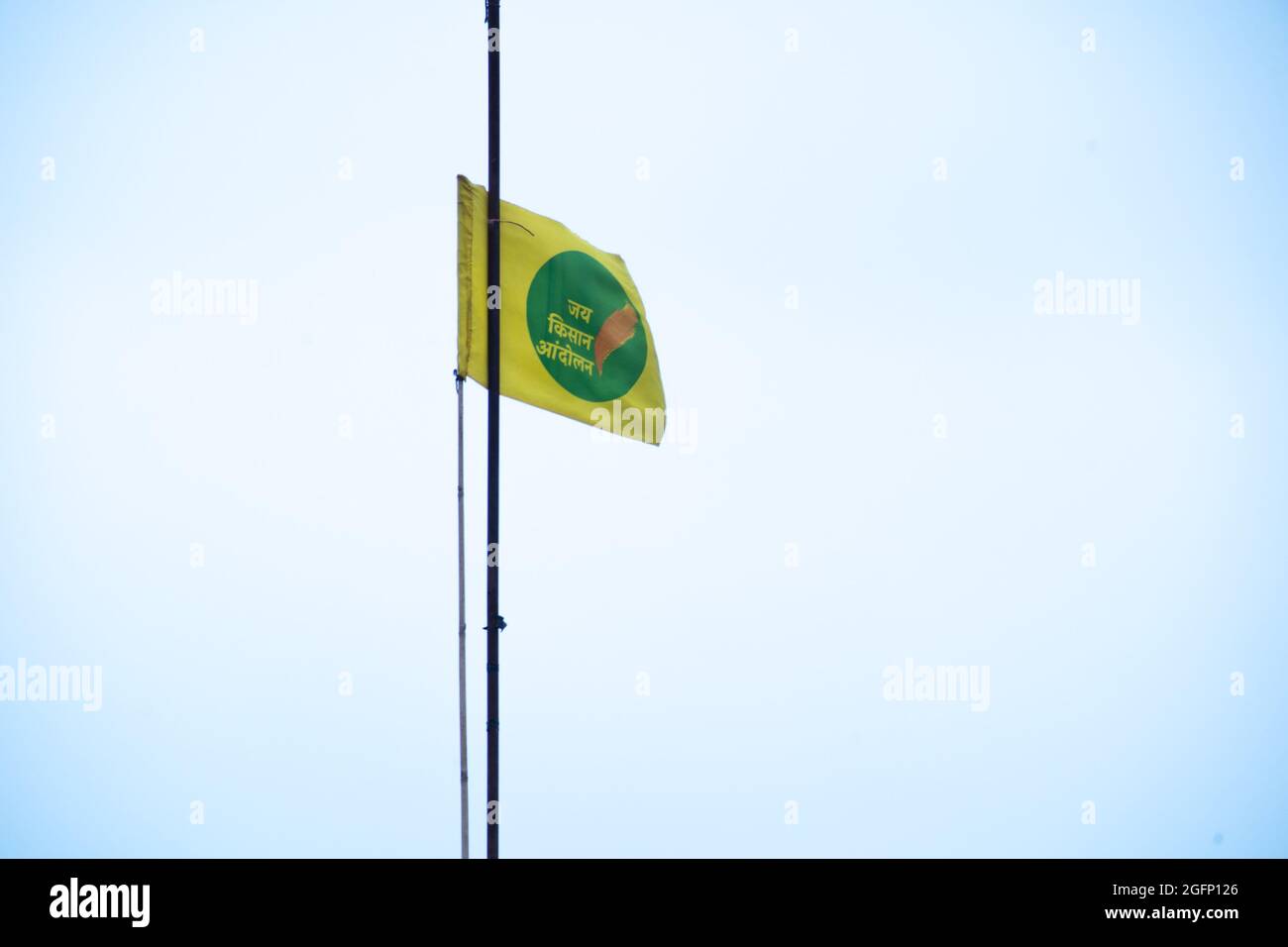 yellow on green flag with the words jai kisan andolan or long live the ...
