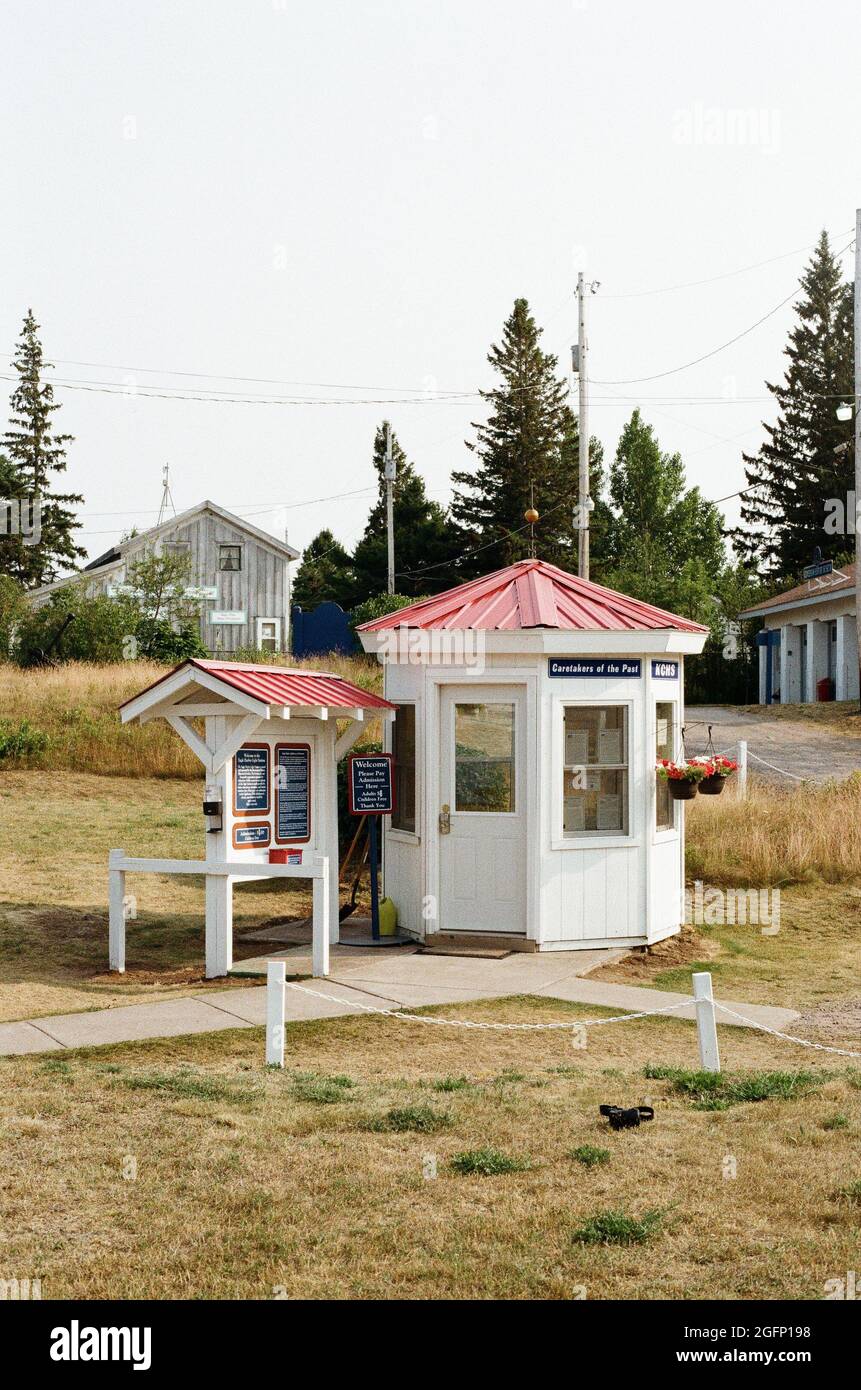 White checkpoint with red roofs, signs and flowers on the background of ...