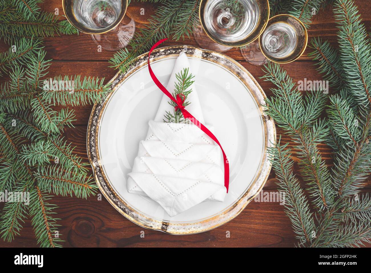 Christmas table setting with pine tree branches and decorations top ...
