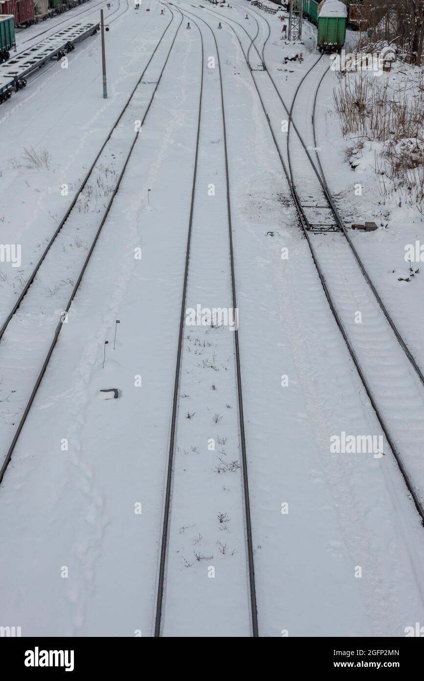 Three snow-covered railway lines at the station. The concept of track ...