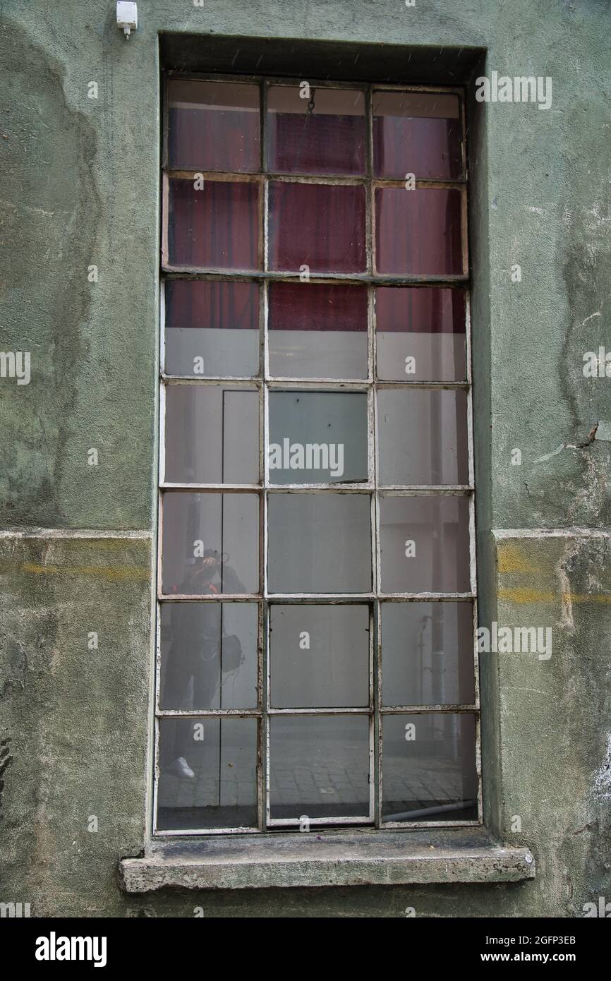 Checkered window frame on the wall of the old concrete building Stock ...