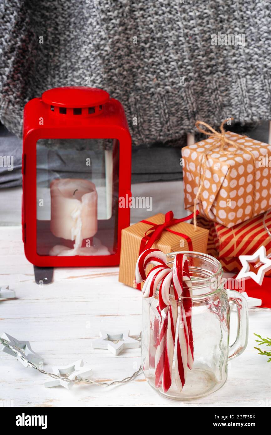 Pile of candy canes on table with red lantern Stock Photo - Alamy