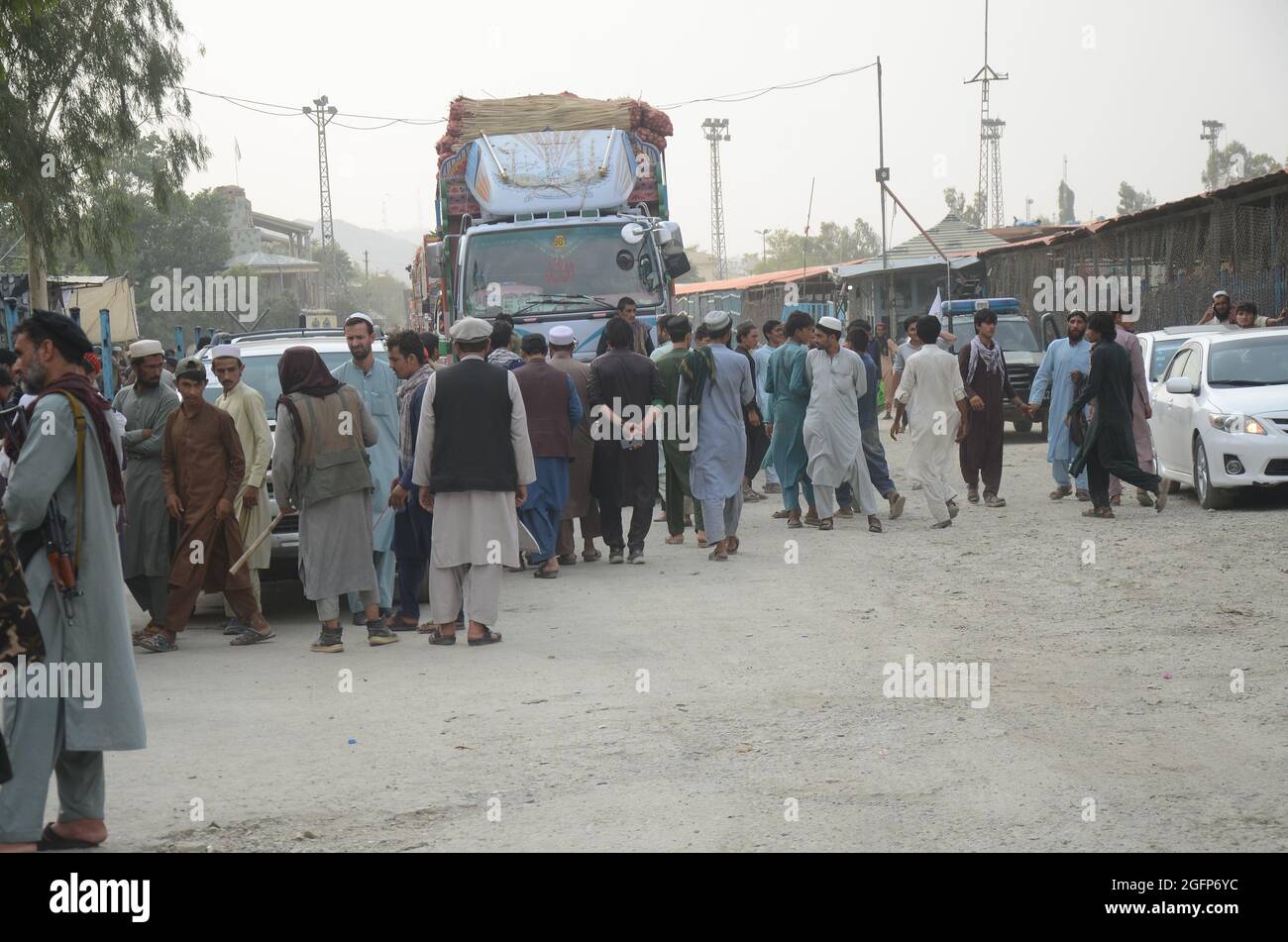 Taliban fighters stand guard on their side at a border crossing point ...