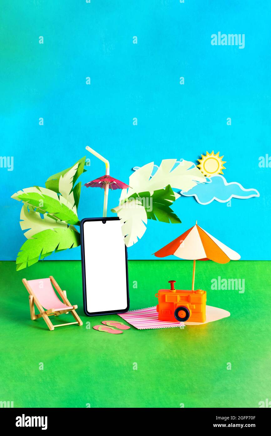 Vertical shot of a phone surrounded by paper cutouts making a tropical ...