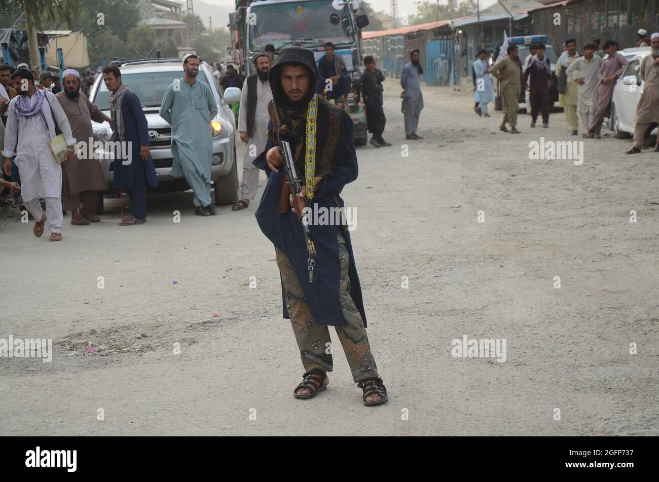 Taliban fighters stand guard on their side at a border crossing point ...