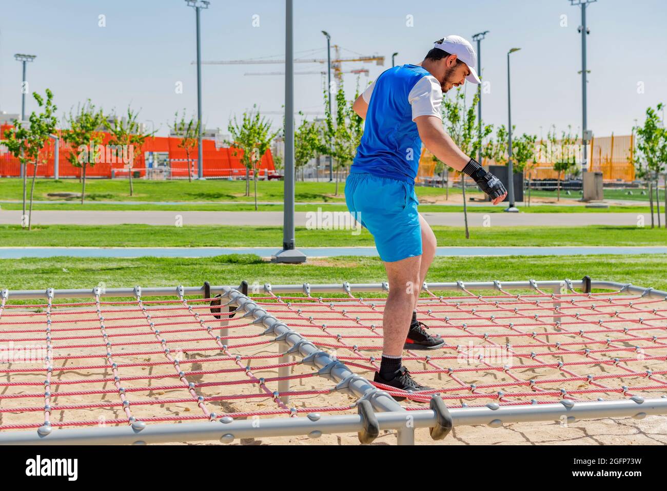 Experienced young sportsman training on a challenging fitness trail in ...