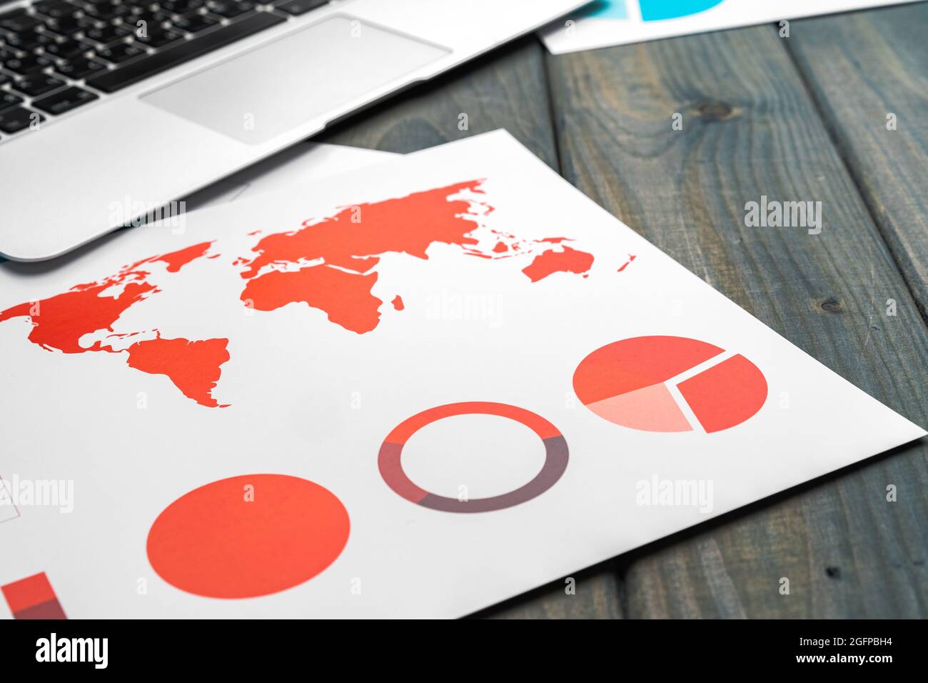 Financial report and laptop on business desk Stock Photo - Alamy