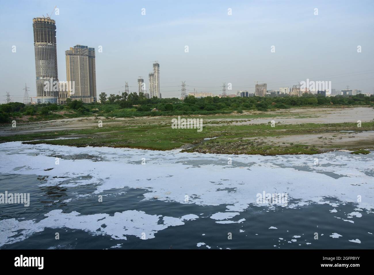 The heavily polluted waters of Yamuna River with a thick white layer of ...