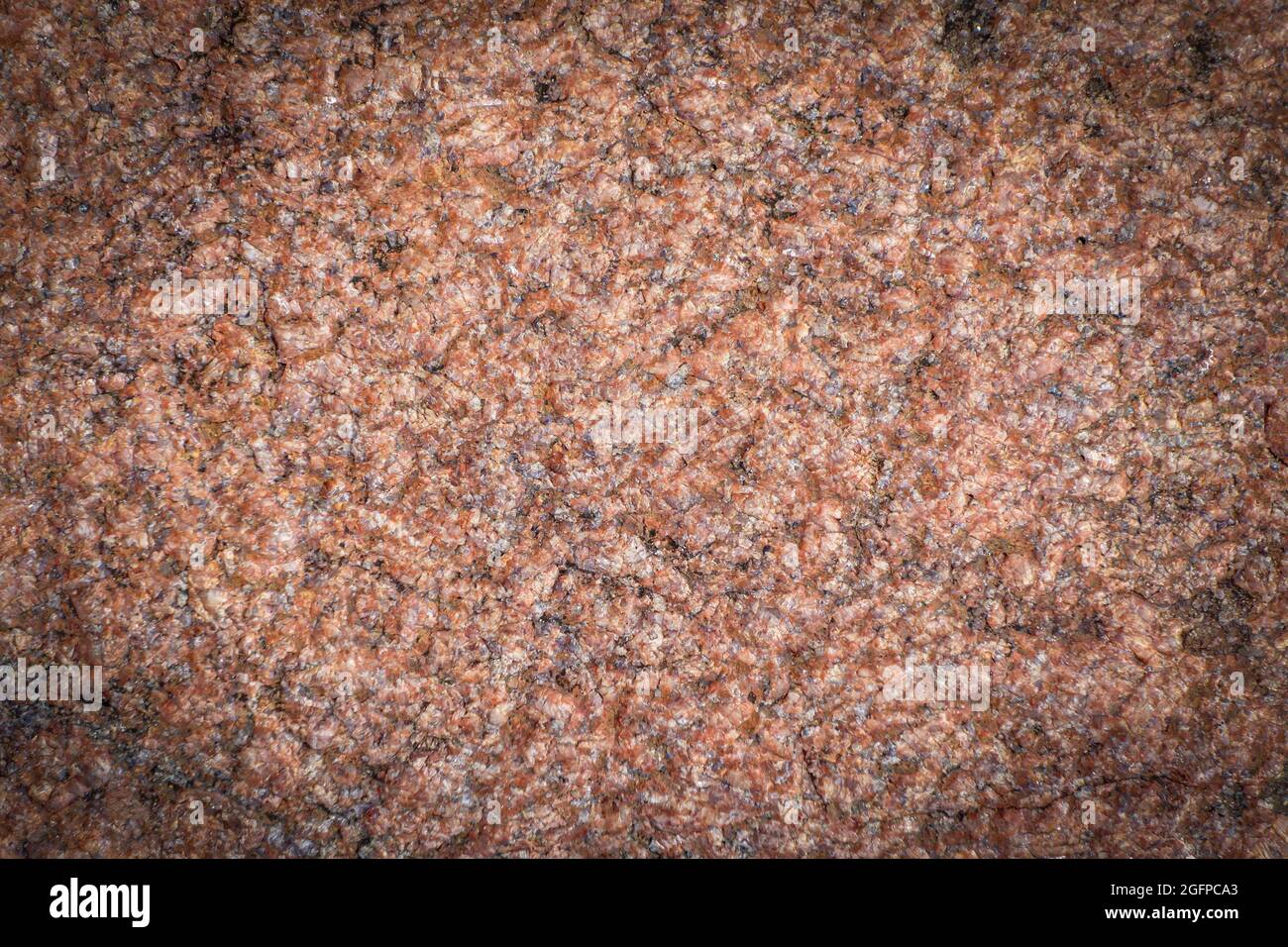 Dark red granite background, structured background with vignetting ...