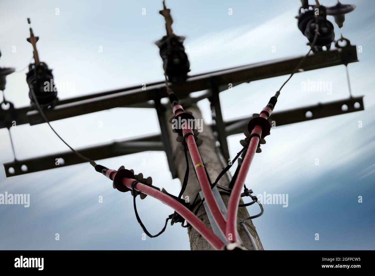 High voltage supply red electric power cables delivering energy looking ...