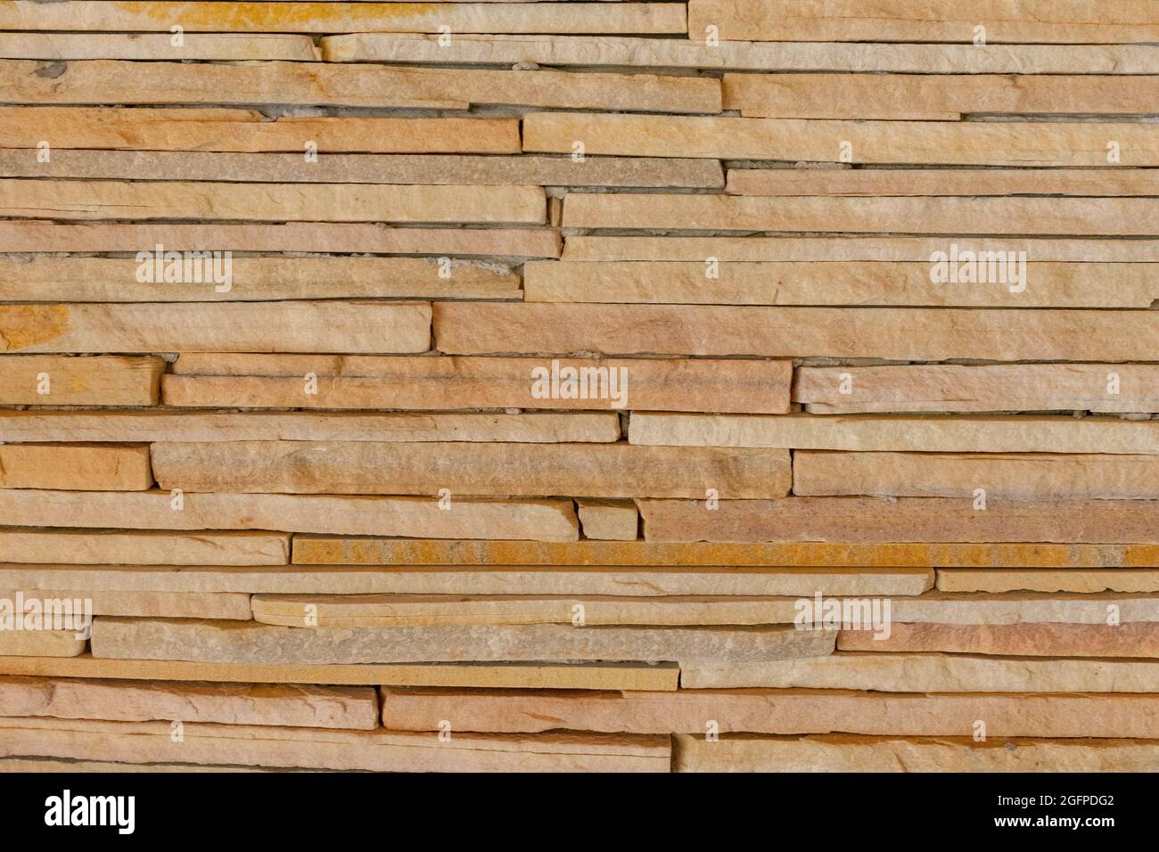Decorative wall of fine stones, with light colored horizontal lines ...