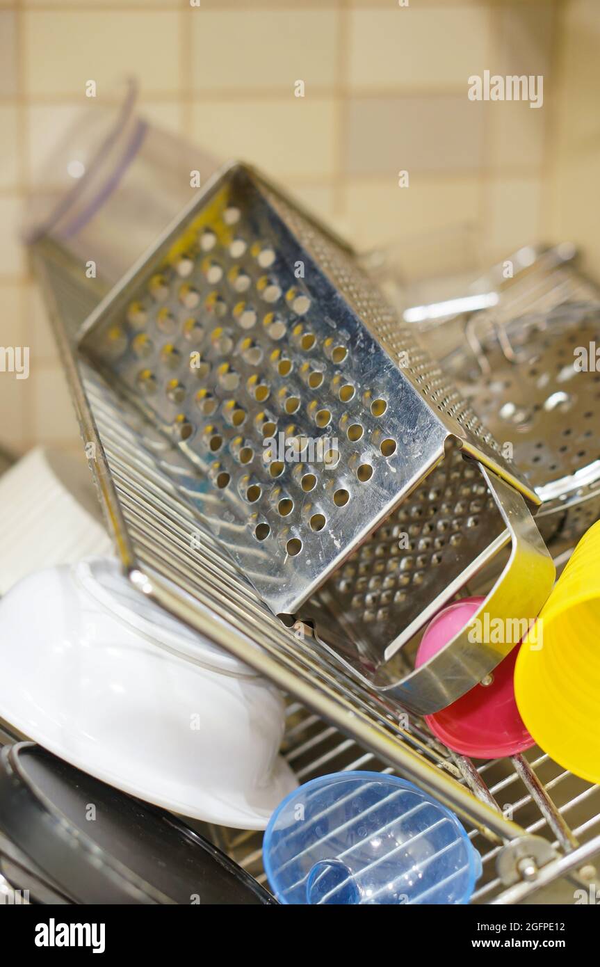 Vertical shot of a grater on the clean dishes in kitchen Stock Photo ...