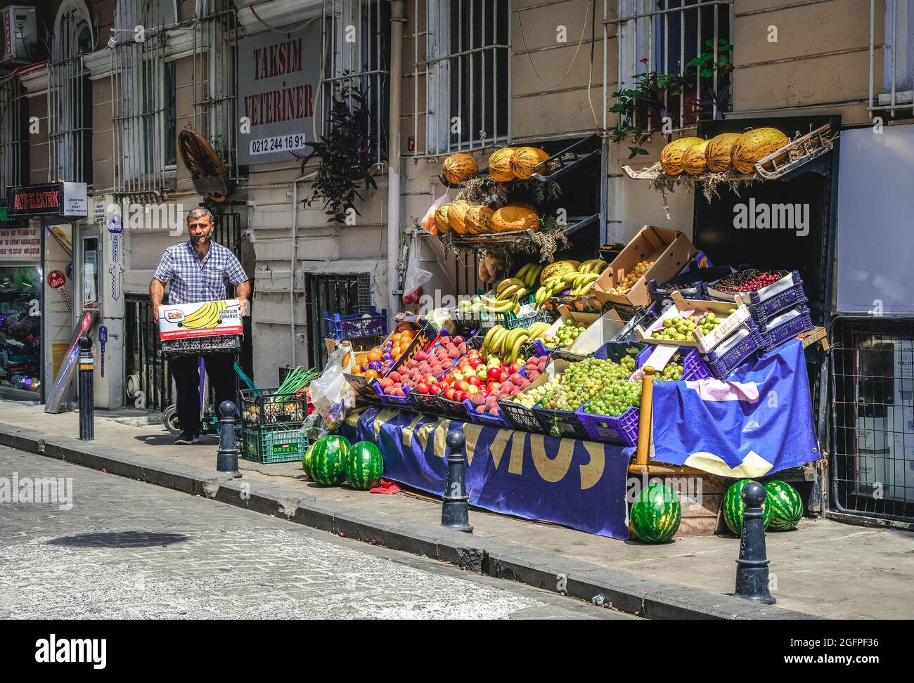 ISTANBUL, TURKEY - Aug 07, 2021: A male fruit seller prepares a shop ...