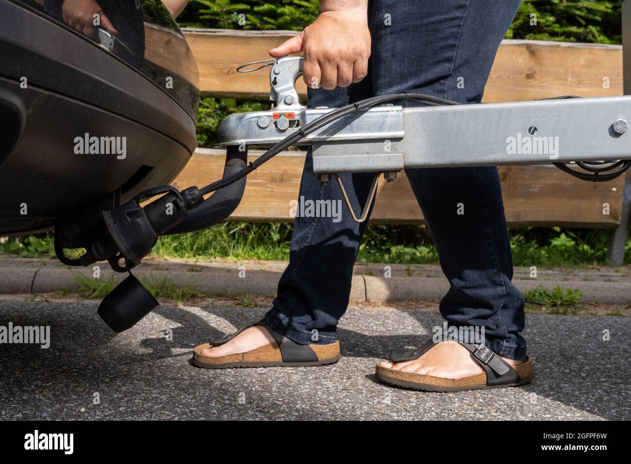 woman couple a trailer (i.s., hooked) into a ball-type tow hitch Stock ...