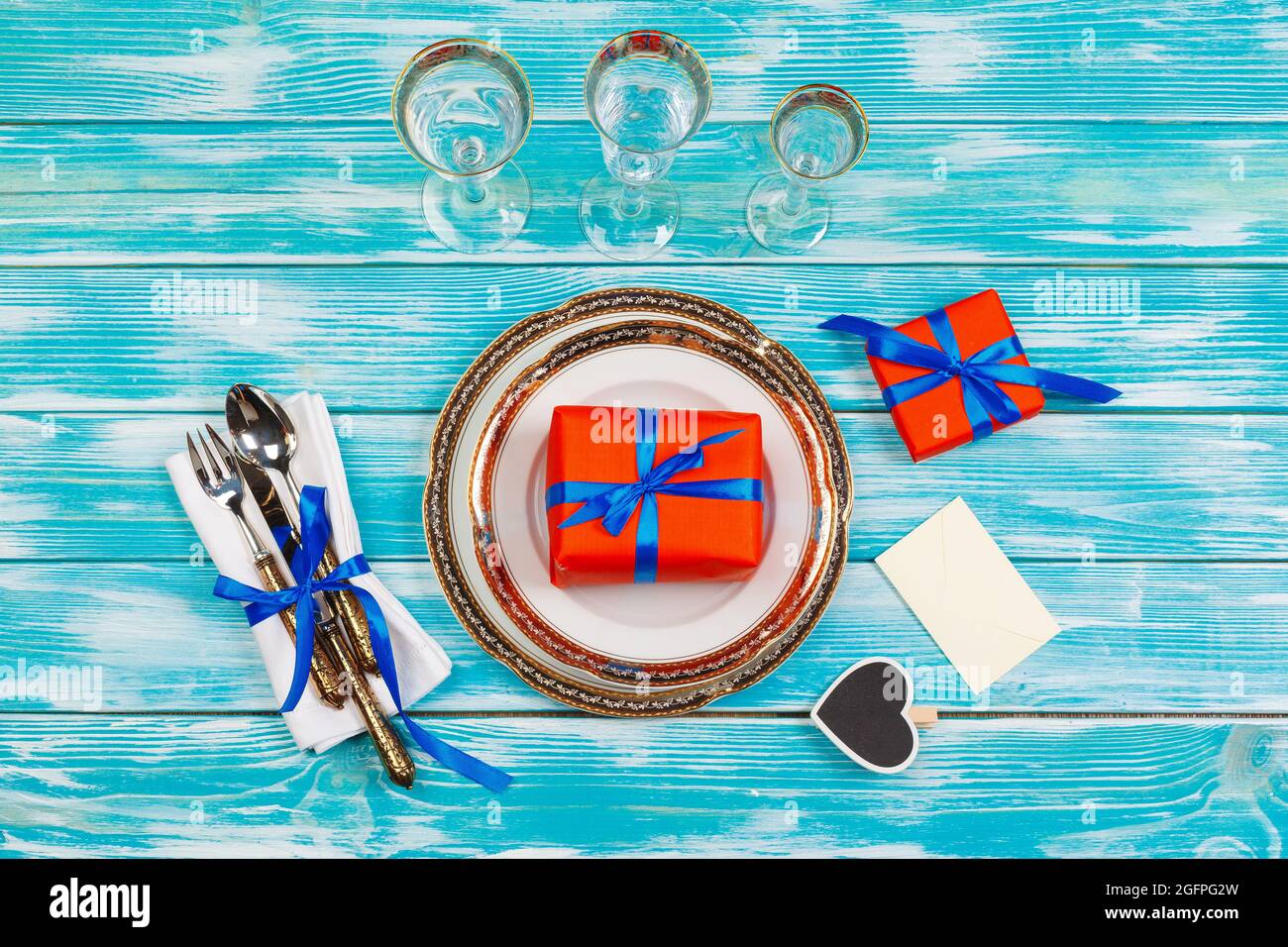 Beautiful table setting on blue wooden background Stock Photo - Alamy