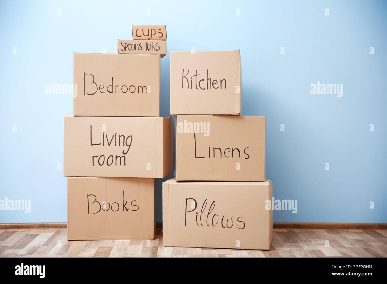 Moving boxes in room on light background Stock Photo - Alamy