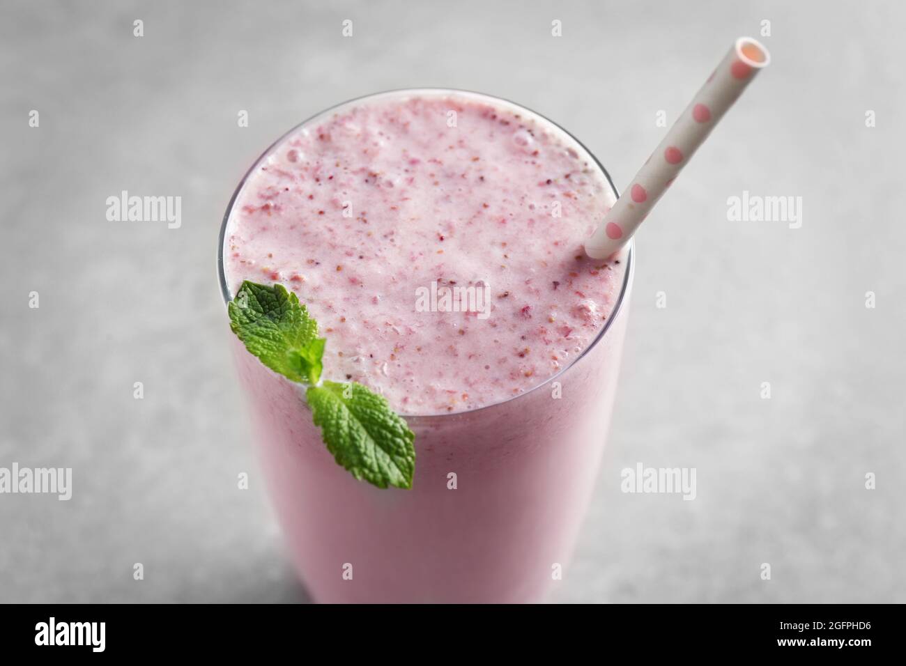 Delicious milkshake on grey textured background Stock Photo - Alamy