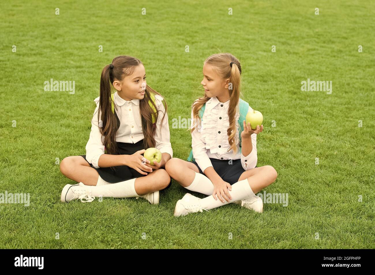 School students girls eating apples for lunch, eat healthy concept ...