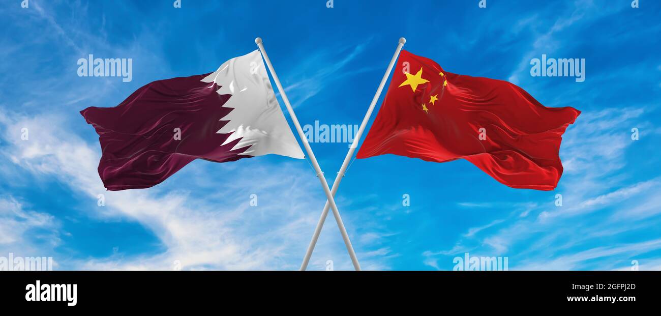 flags of China and Qatar waving in the wind on flagpoles against sky ...