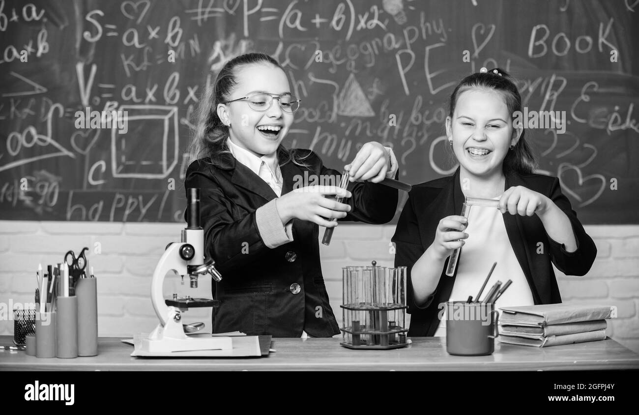 Chemistry research. Biology lesson. Little girls in school lab ...